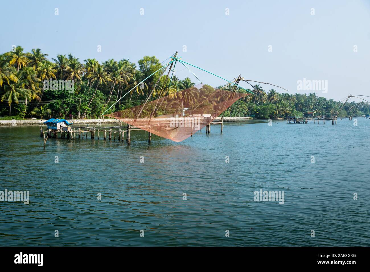 Orange Chinese fisher net along the kollam kottapuram waterway along ...