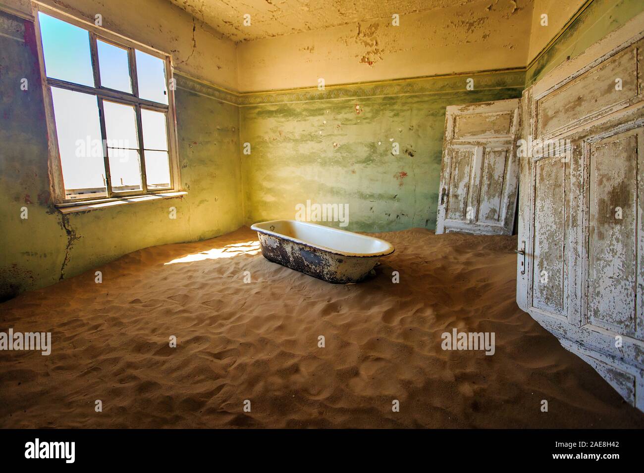 Abandoned and forgotten building and room being taken over by encroaching sandstorm, Kolmanskop ...