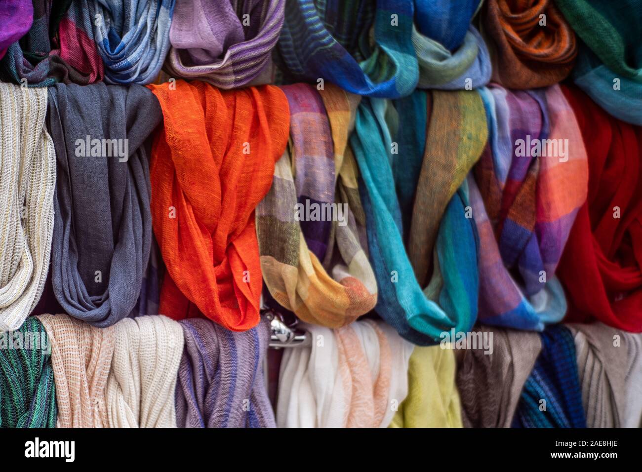 a rack with various and colorful summer scarves from a street vendor ...