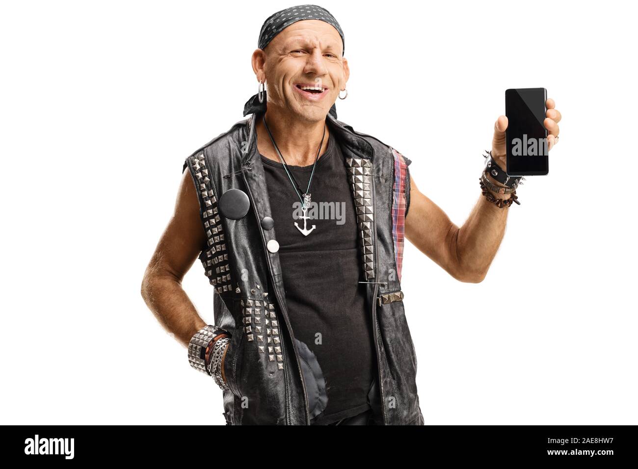 Happy punk holding a mobile phone isolated on white background Stock ...