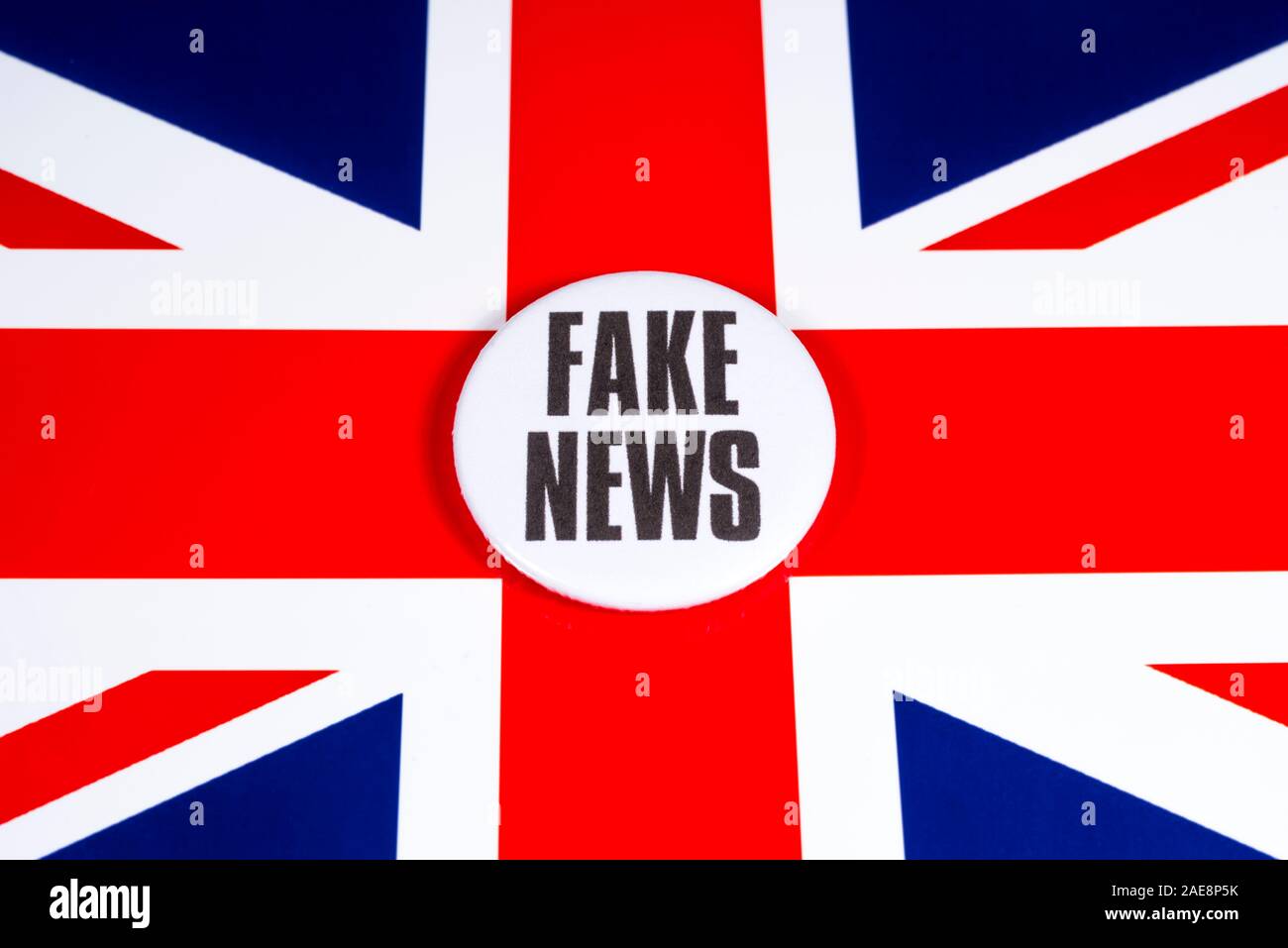 A Fake News pin badge pictured over the flag of the United Kingdom ...
