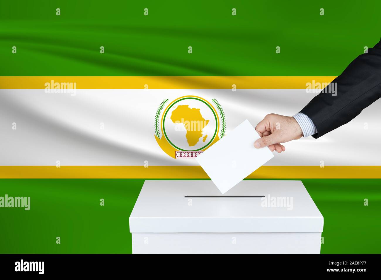 Election in African Union. The hand of man putting his vote in the ...