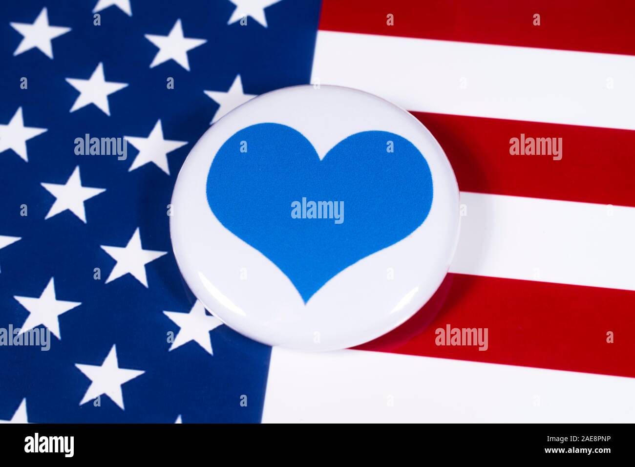 A blue heart symbol, pictured over the flag of the United States of ...