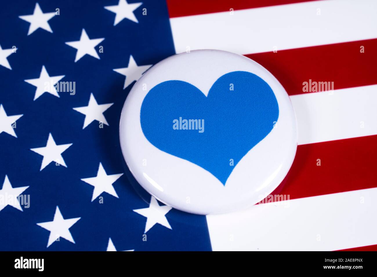 A blue heart symbol, pictured over the flag of the United States of ...