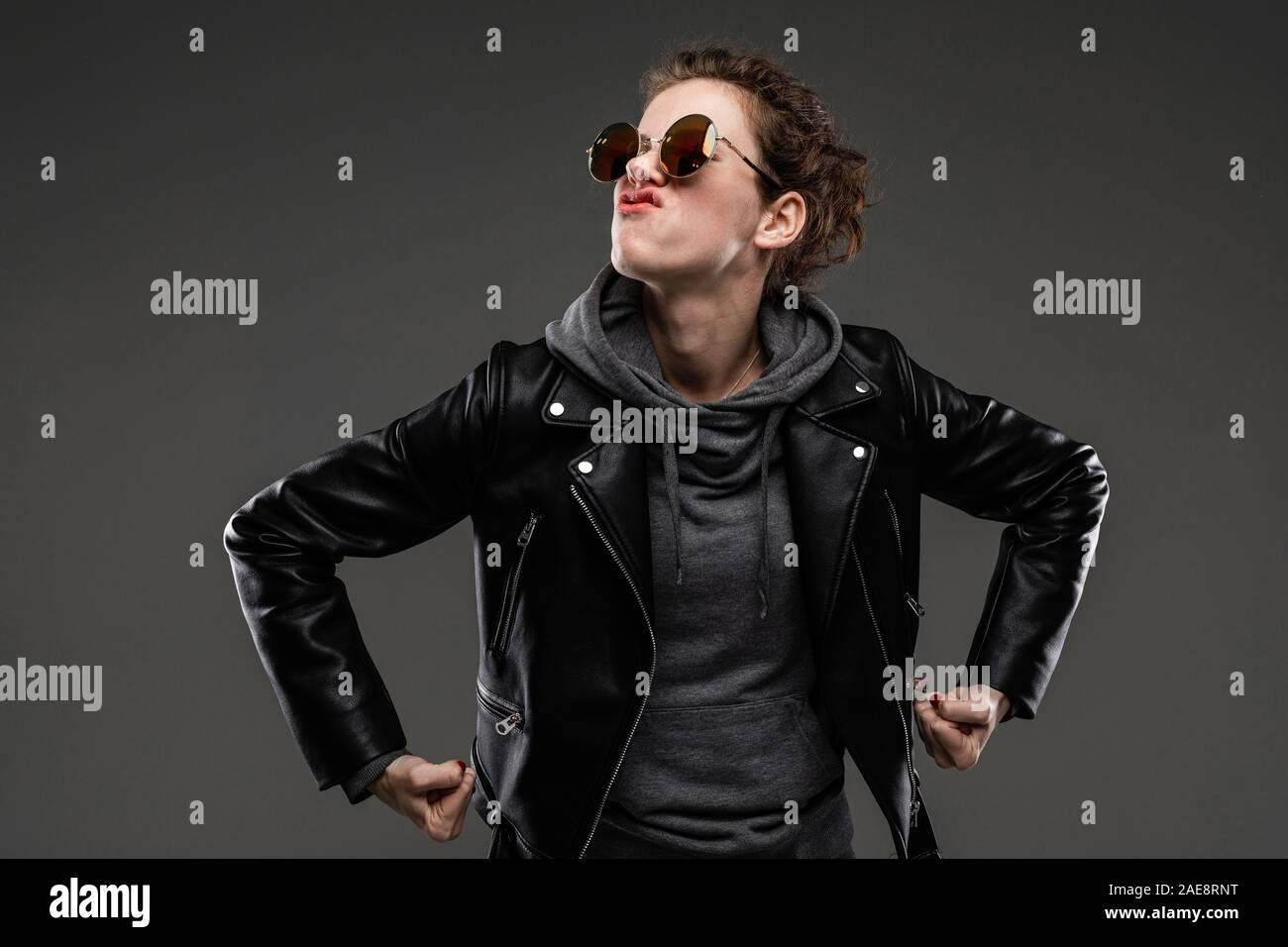 Stubborn caucasian girl with rough facial features in a black jacket ...