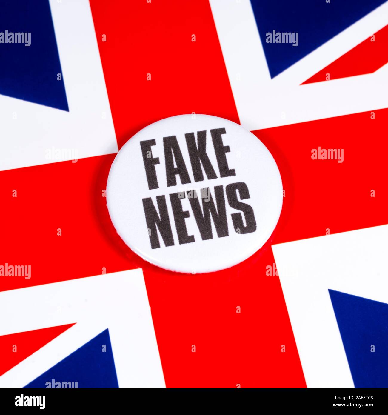A Fake News pin badge pictured over the flag of the United Kingdom ...