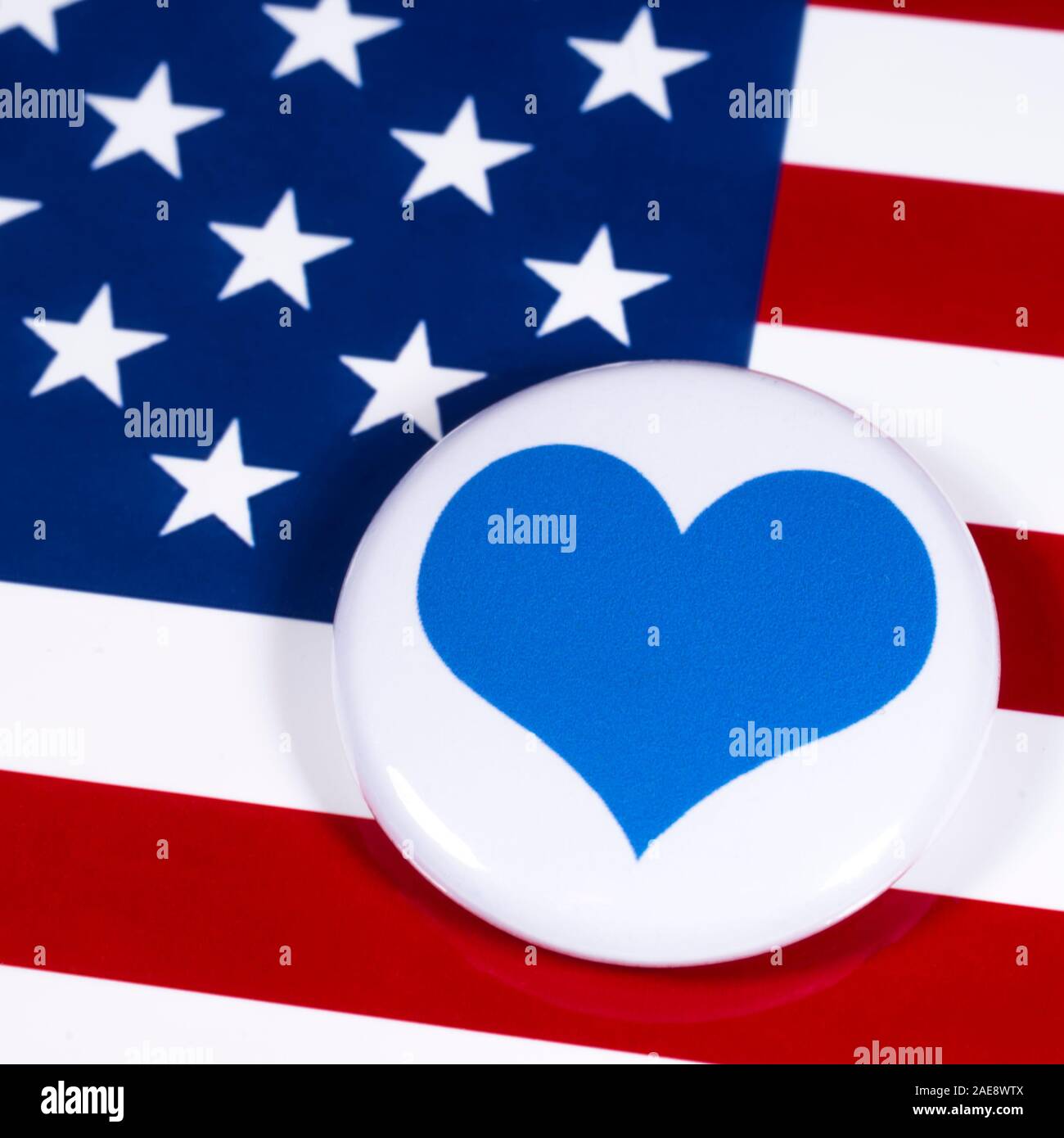 A blue heart symbol, pictured over the flag of the United States of ...