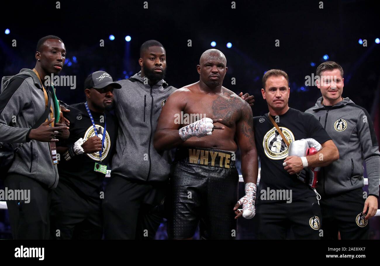 Dillian Whyte (centre) with trainer Mark Tibbs (2nd right) after ...