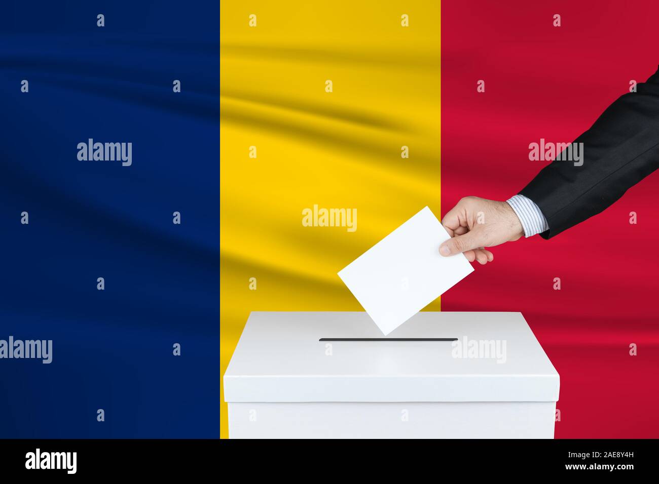 Election in Chad. The hand of man putting his vote in the ballot box ...