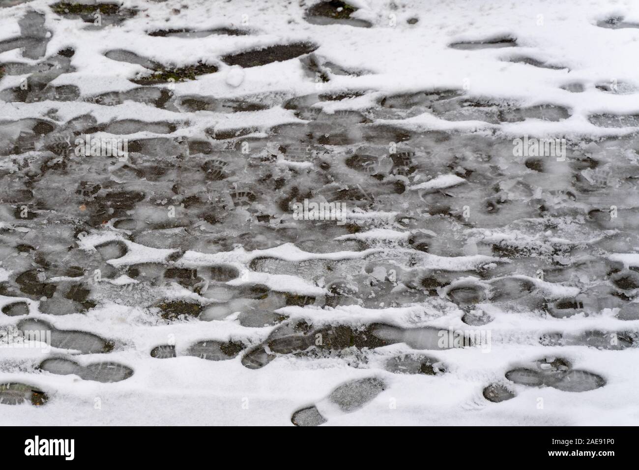 The first snow on the street. Traces on the snowy pavement. Winter ...