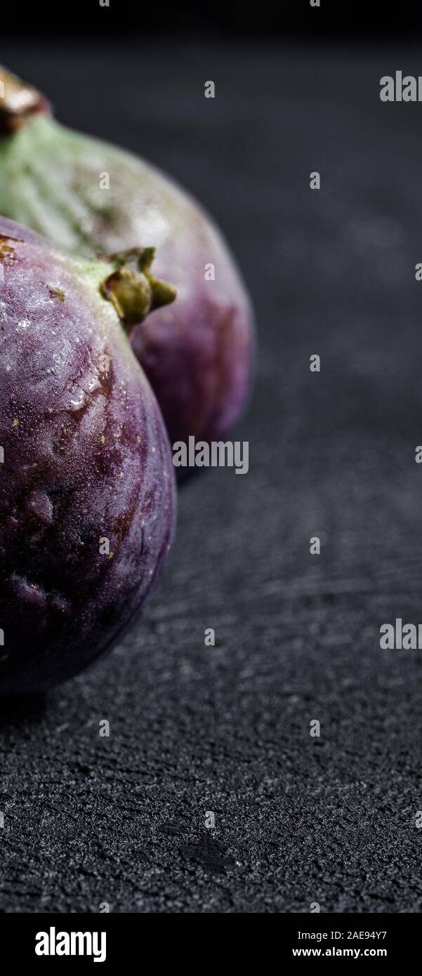 fresh figs close-up on black background. dark moody photo Stock Photo ...