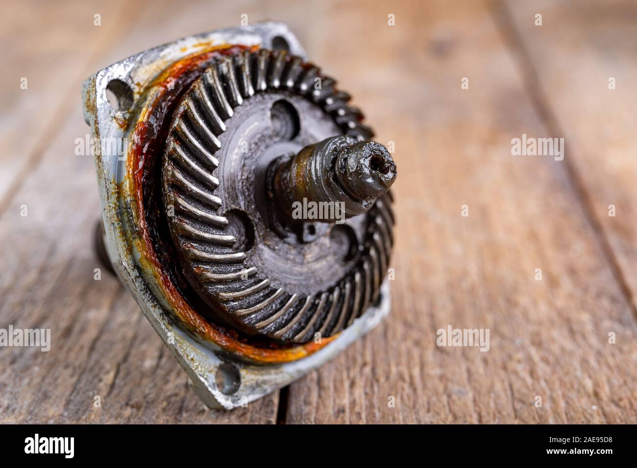 Broken gear on the workbench. Spare parts for angle grinders. Dark ...