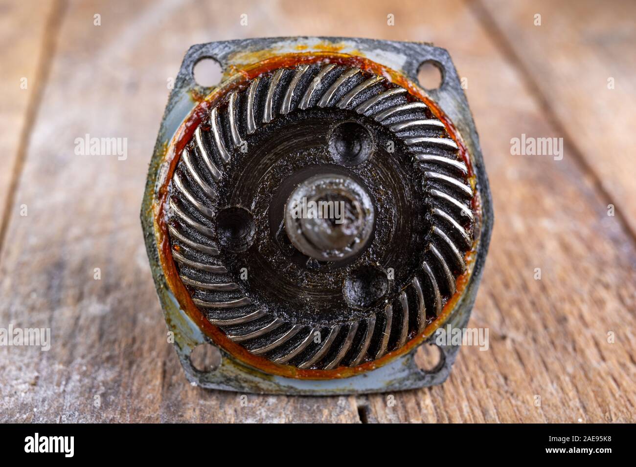 Broken gear on the workbench. Spare parts for angle grinders. Dark ...