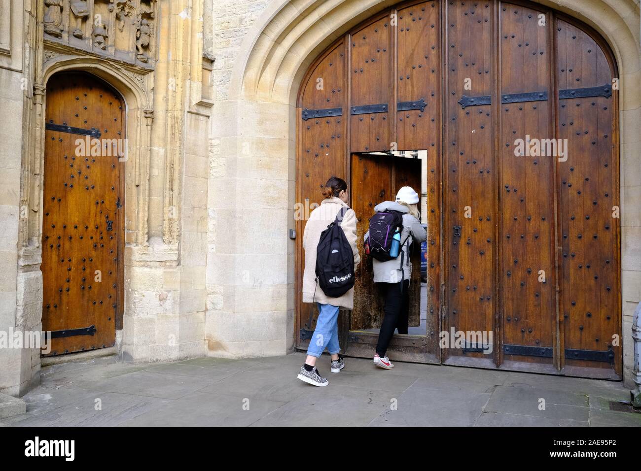 Students entering their college at Oxford University through a wooden ...