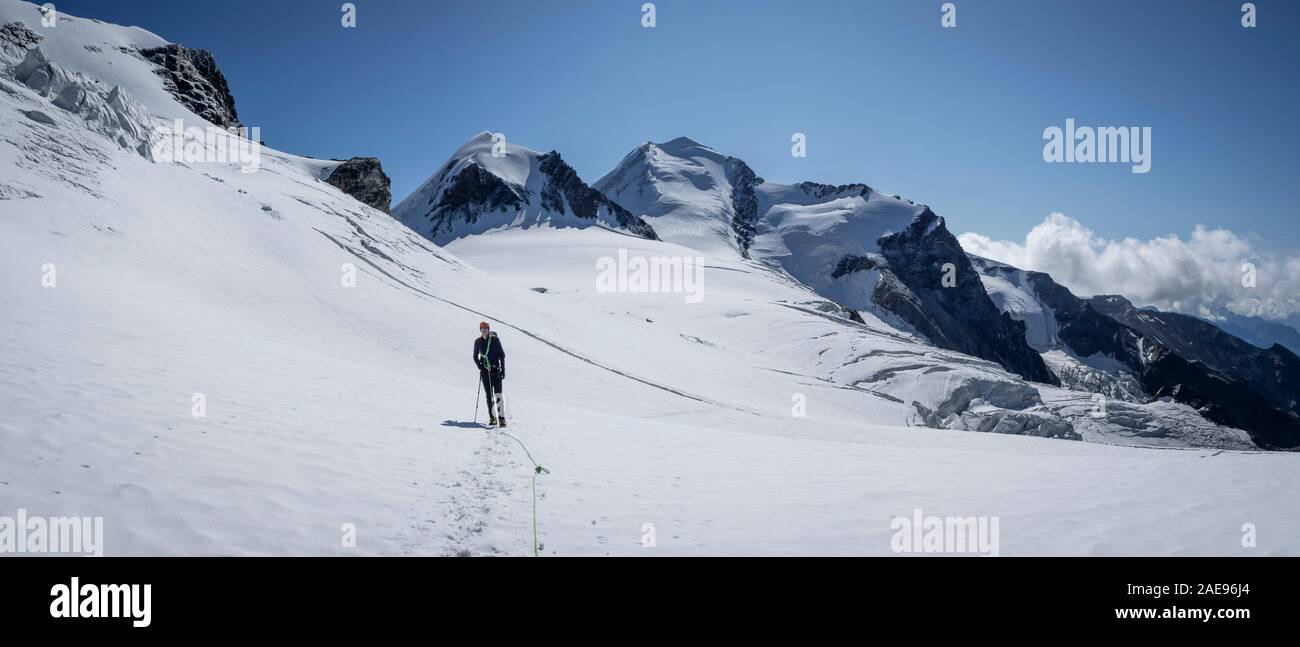 A climber walking on the glacier below the Breithorn Stock Photo - Alamy