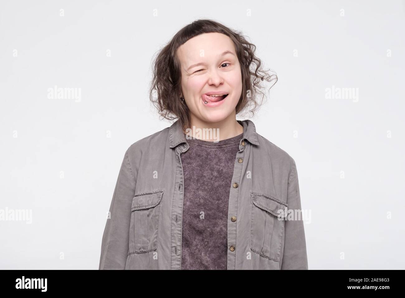 Pretty caucasian girl sticking out tongue, teasing someone, having ...