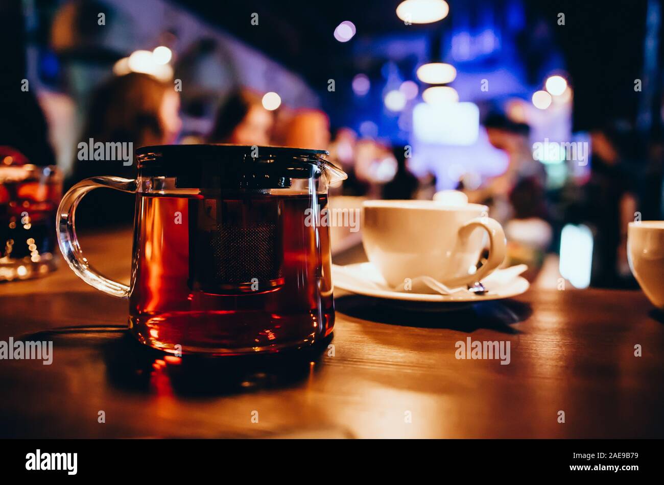 Red tea in a teapot on wooden bar counter. Blurred background Stock ...