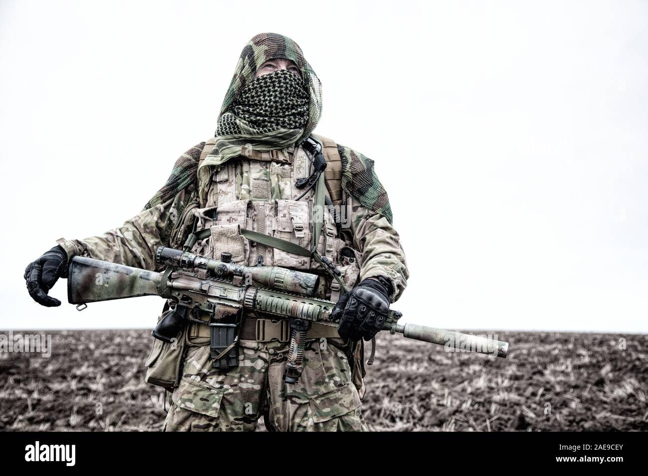 Army sniper standing in field with rifle Stock Photo - Alamy