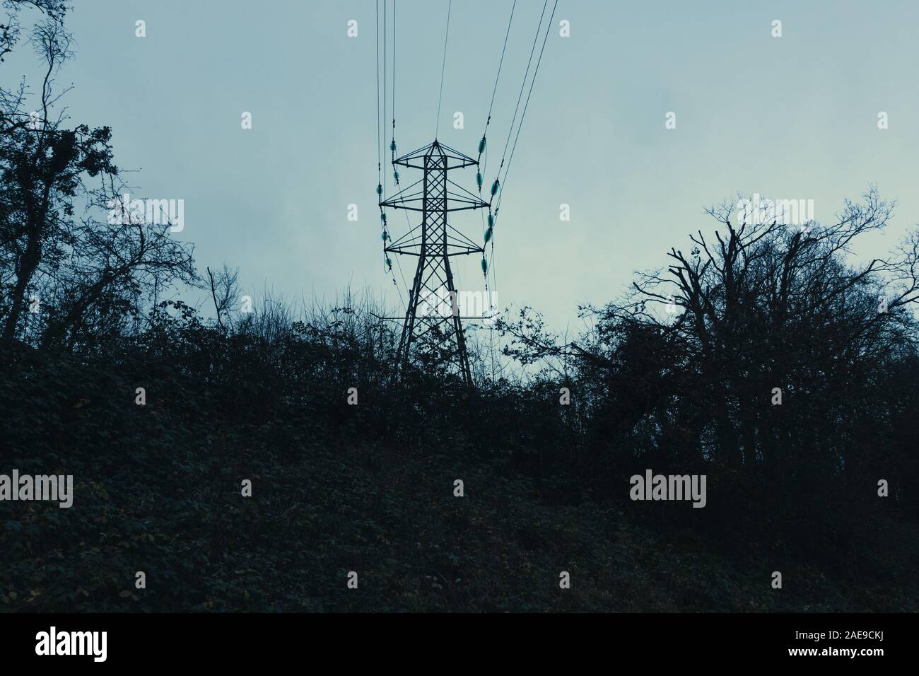 A dark spooky, moody edit. Looking up at an energy electricity pylon on ...