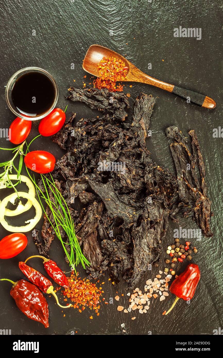 Dried meat on kitchen table. Domestic production of dried beef. Meat ...