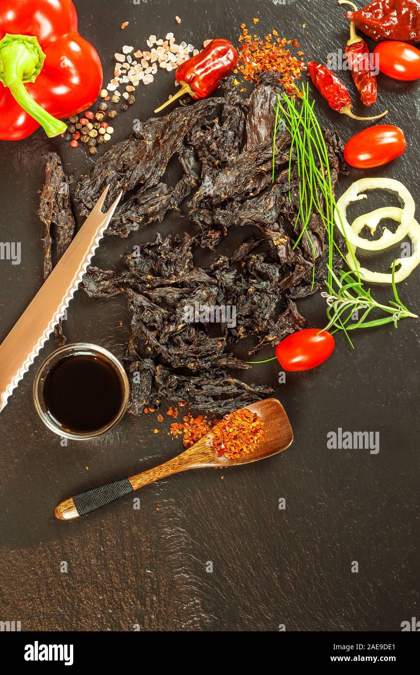 Dried meat on kitchen table. Domestic production of dried beef. Meat ...