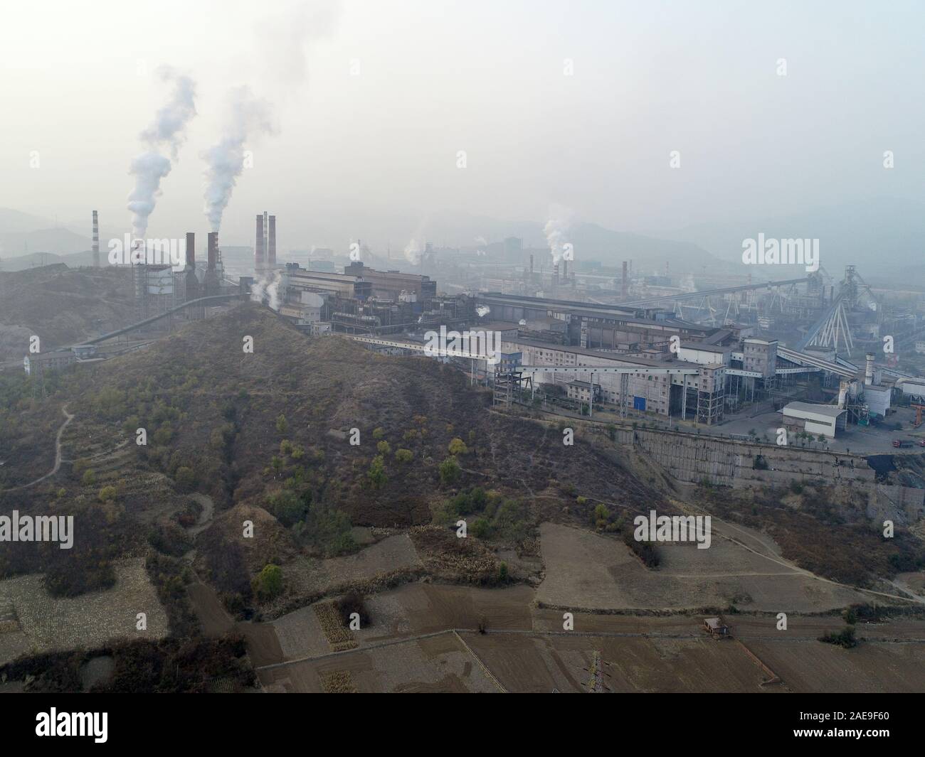 Aerial view of big factory in China. Air pollution by smoke coming out ...