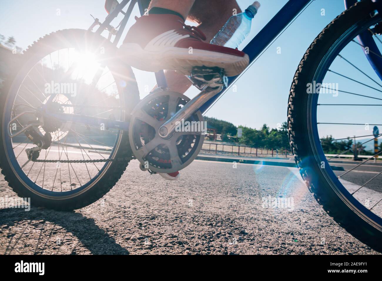 Fit male biker cyclist riding his bike cycle on an asphalt road at ...