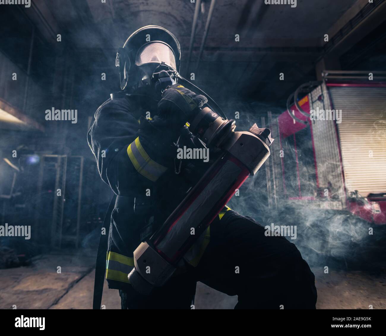 Portrait of a female firefighter wearing a helmet and all safety ...