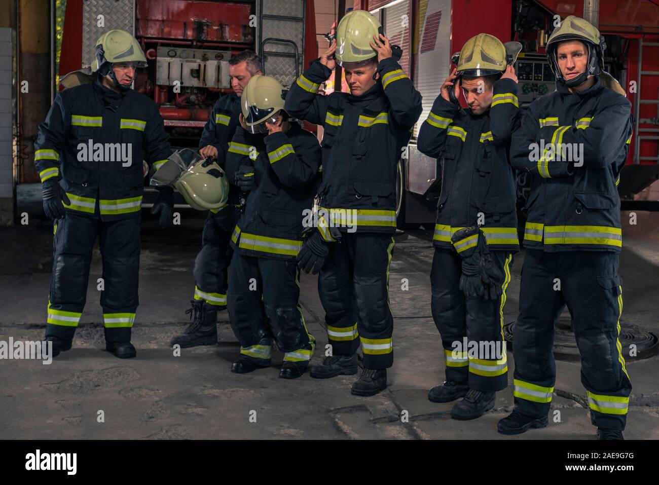 Group of firefighters standing confident with arms crossed. Firemen ...