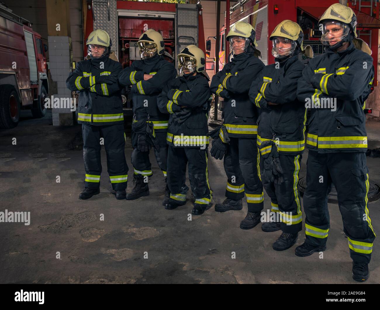 Group of firefighters standing confident with arms crossed. Firemen ...