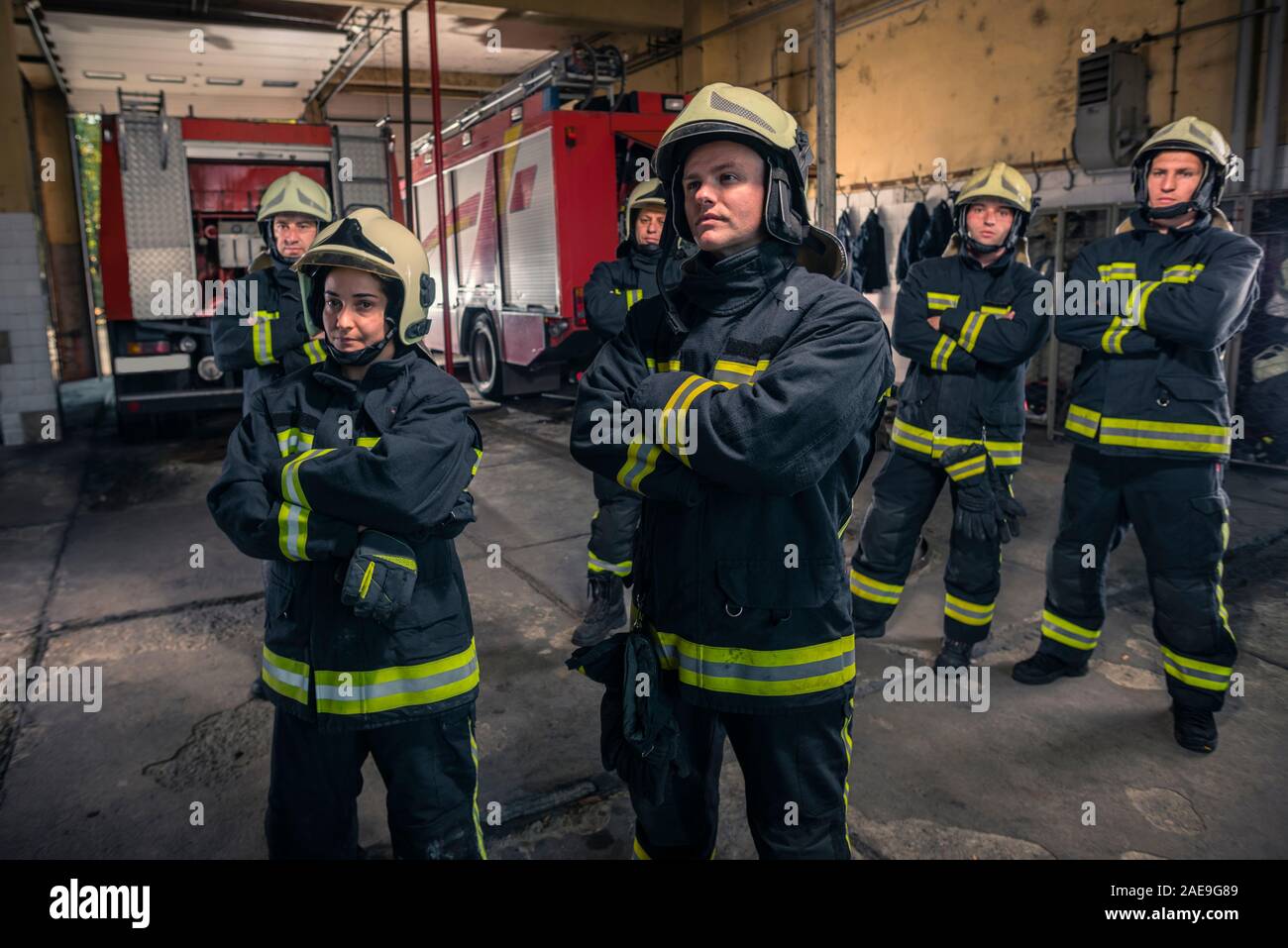 Group of firefighters standing confident with arms crossed. Firemen ...