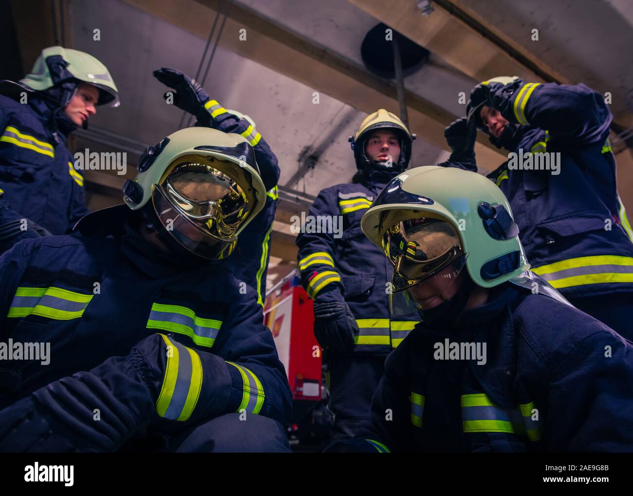 Portrait of group of firefighters wearing protective uniform inside the ...