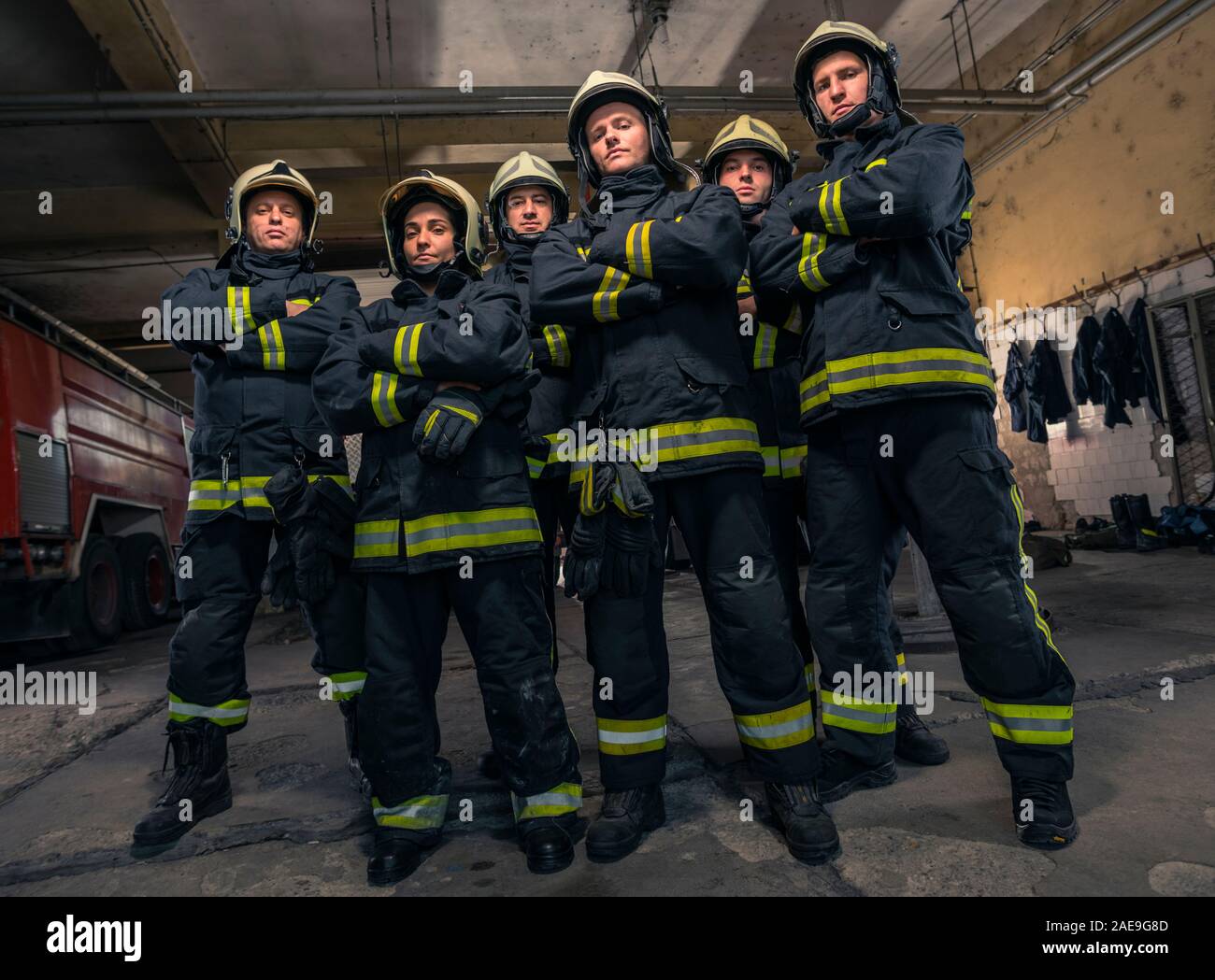Group of firefighters standing confident with arms crossed. Firemen ...