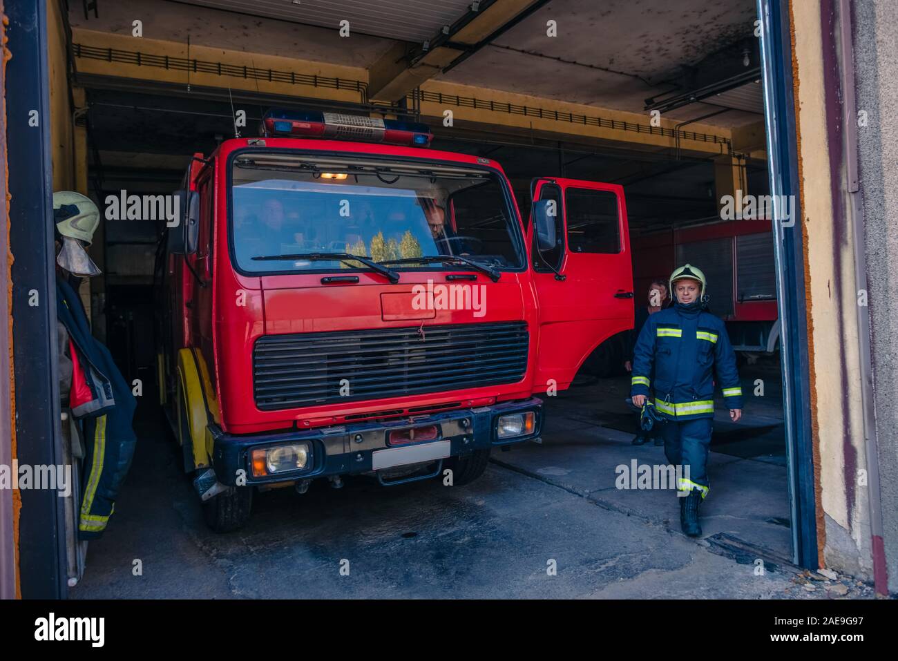 Fire engine inside the garage of the fire department Stock Photo - Alamy