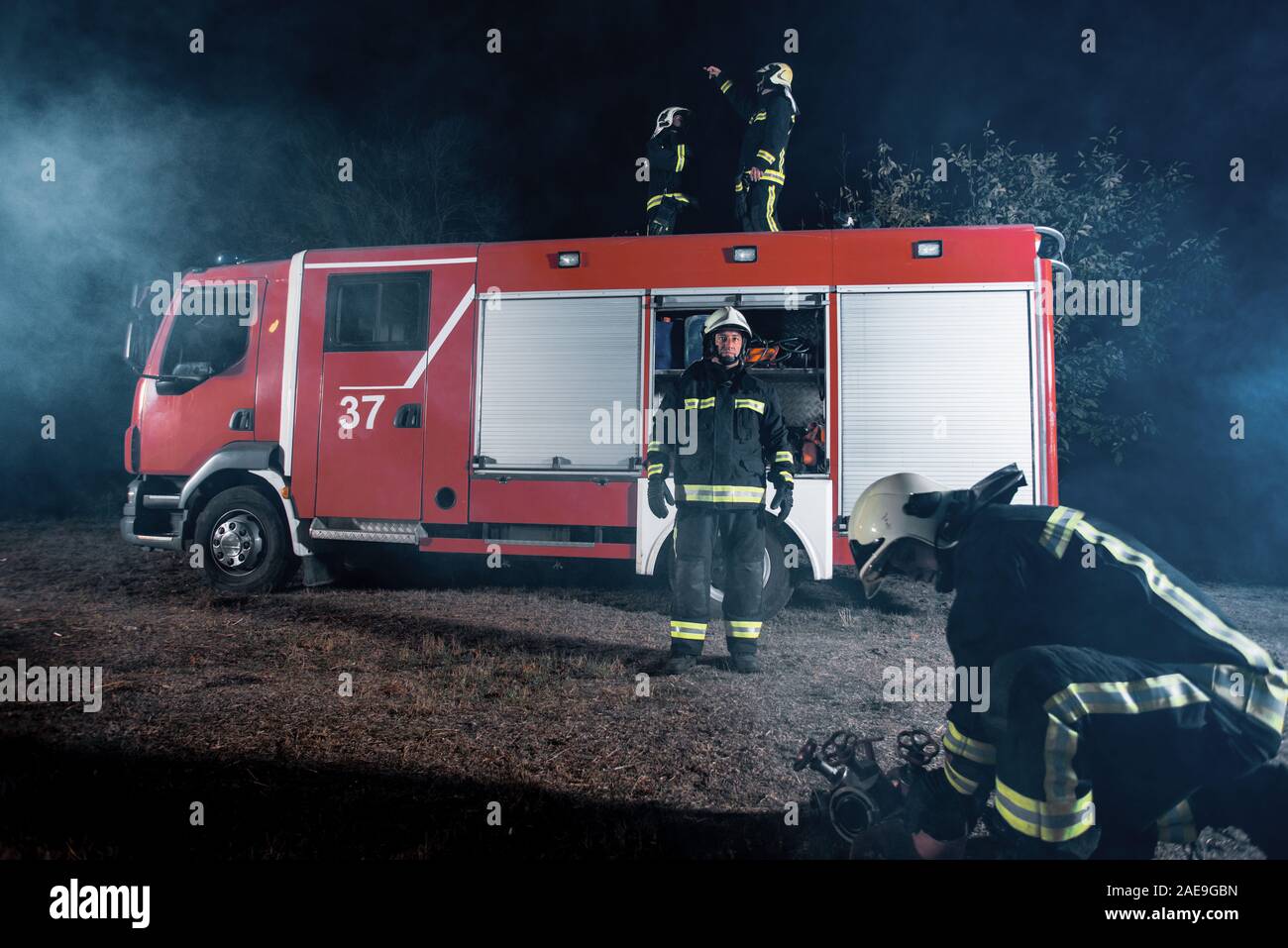 Firemen getting ready during a firefighting intervention Stock Photo ...