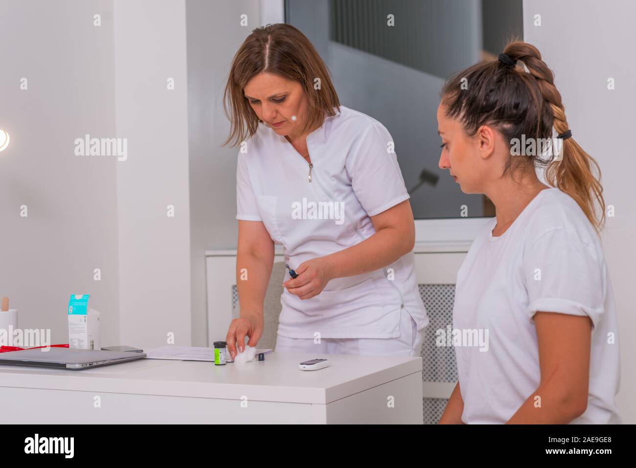 Doctor checking blood sugar level with a glucometer girls levels Stock ...