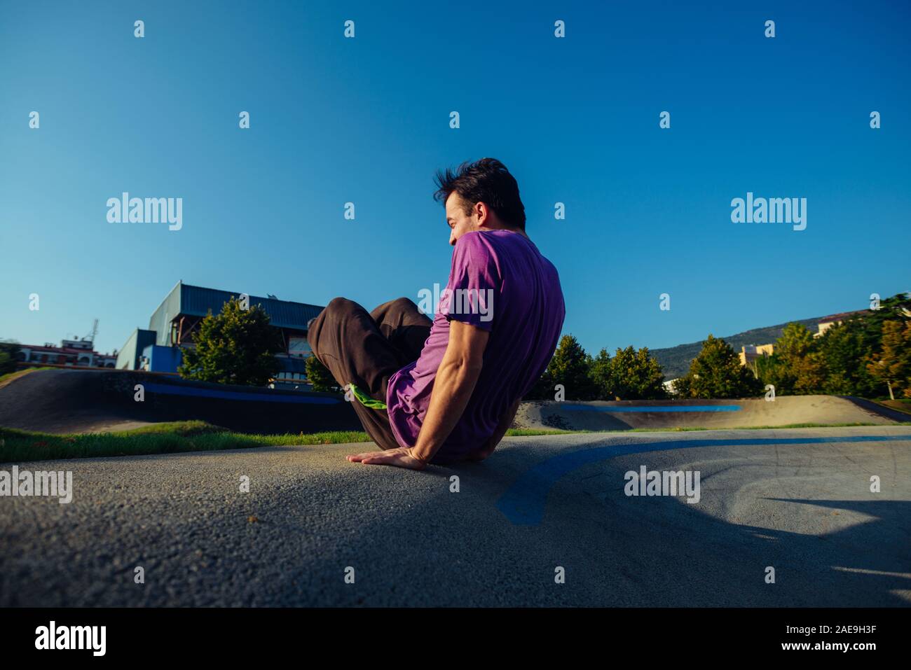 Acrobat practicing parkour exercises at the local skatepark Stock Photo ...