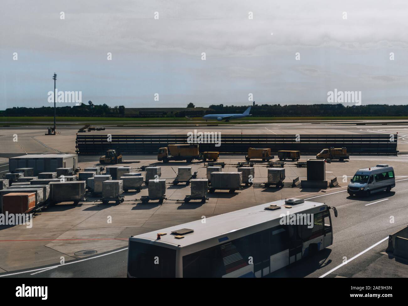 Apron area at the aerodrome with an airport bus, storage containers and ...