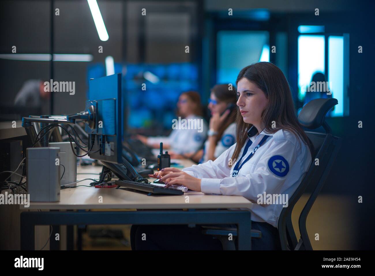 Security guard monitoring modern CCTV cameras in a surveillance room ...