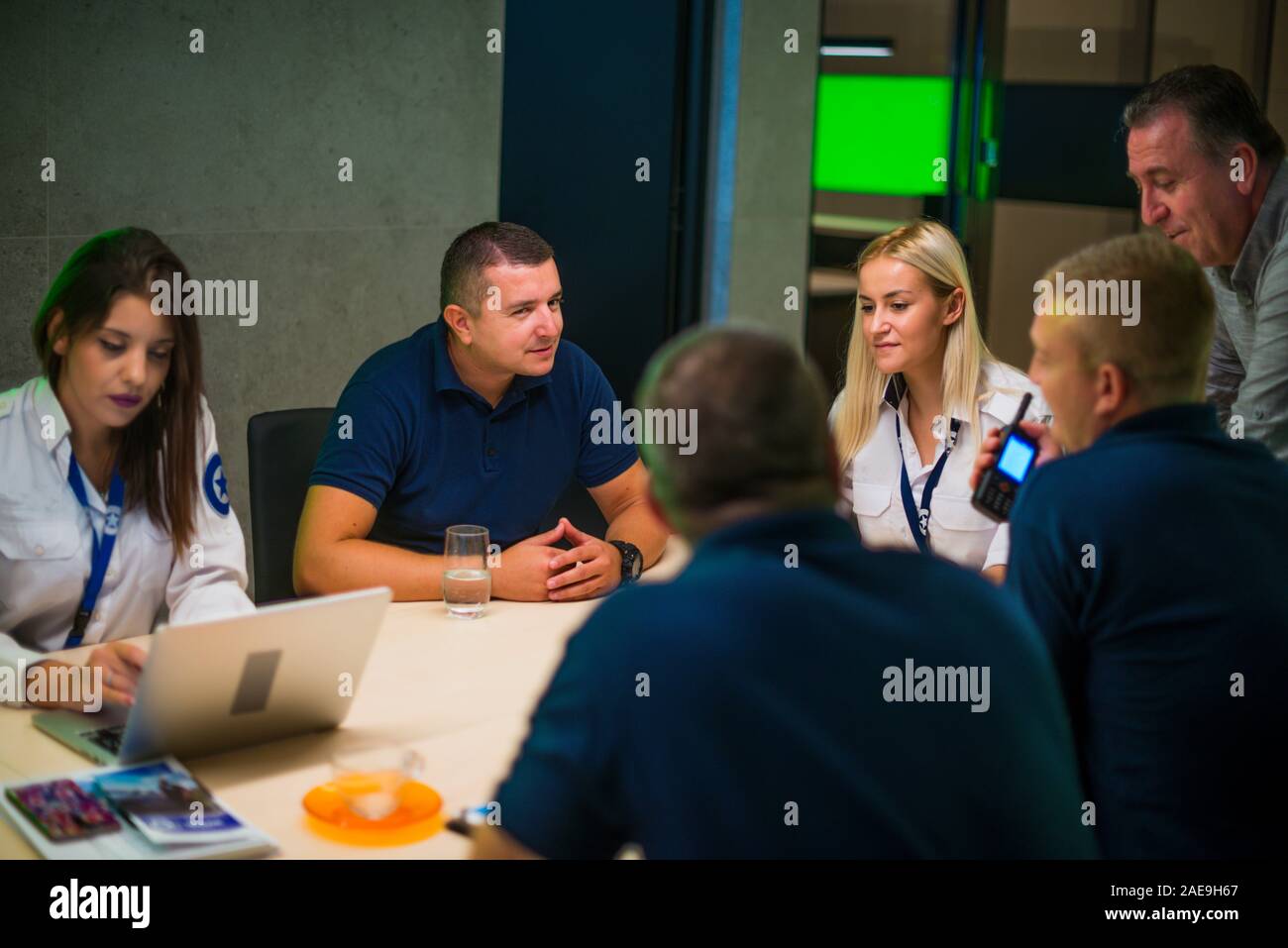 Security guard monitoring modern CCTV cameras in a surveillance room ...