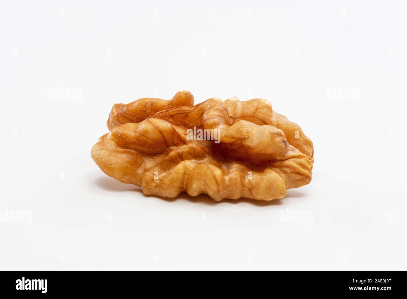 One peeled walnut on a white background Stock Photo - Alamy