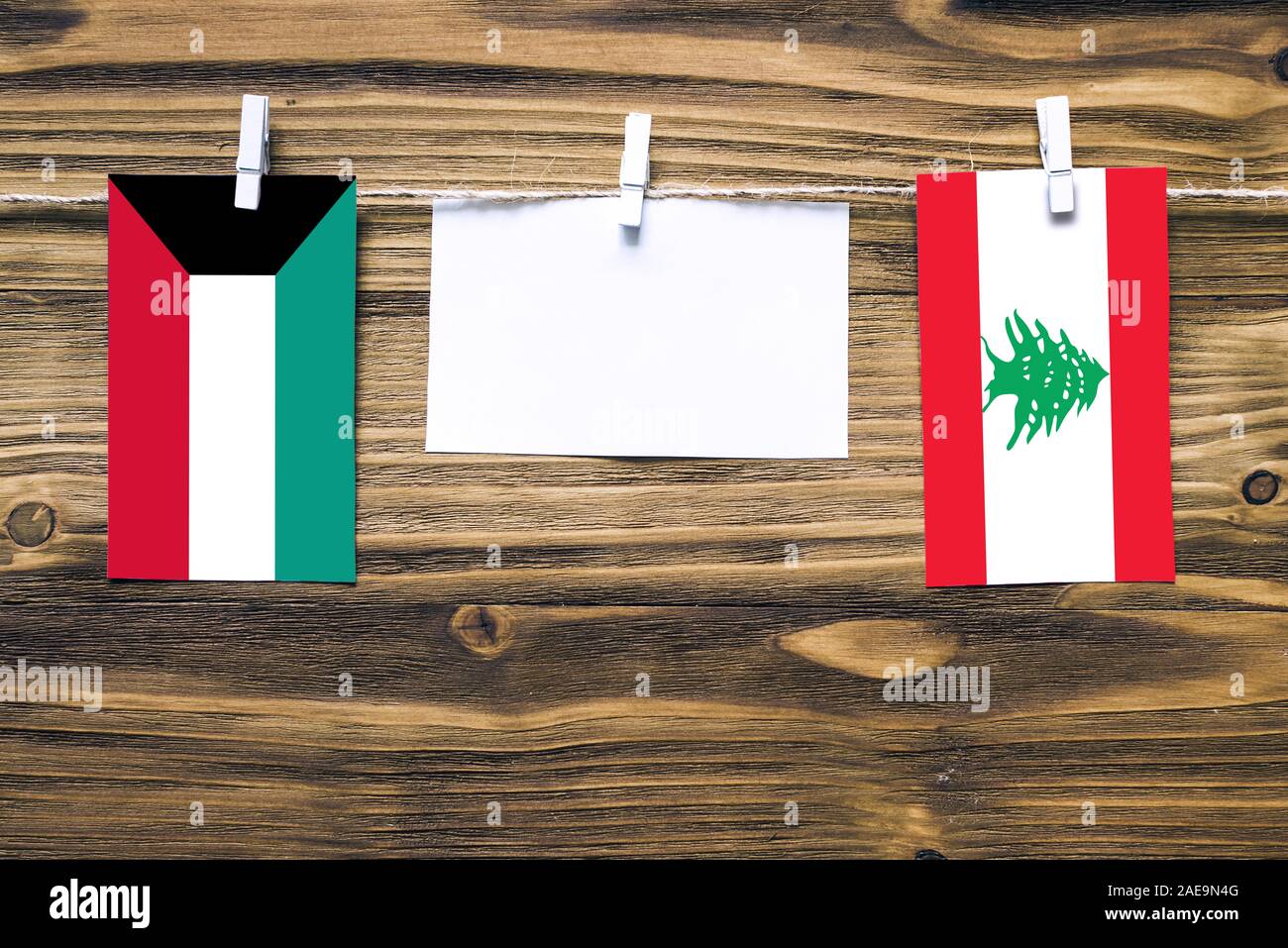 Hanging flags of Kuwait and Lebanon attached to rope with clothes pins ...