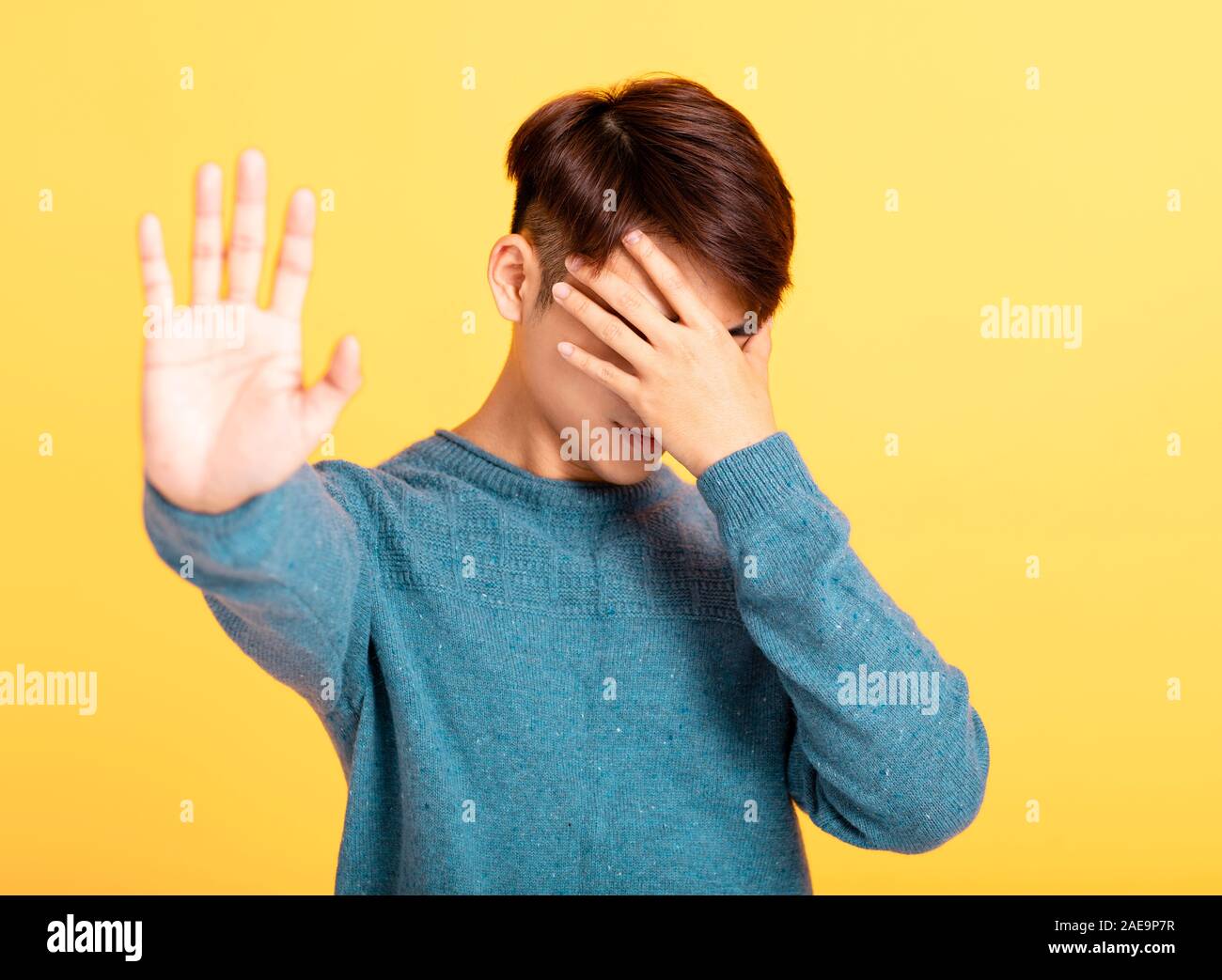 young man showing his hand hiding face Stock Photo - Alamy