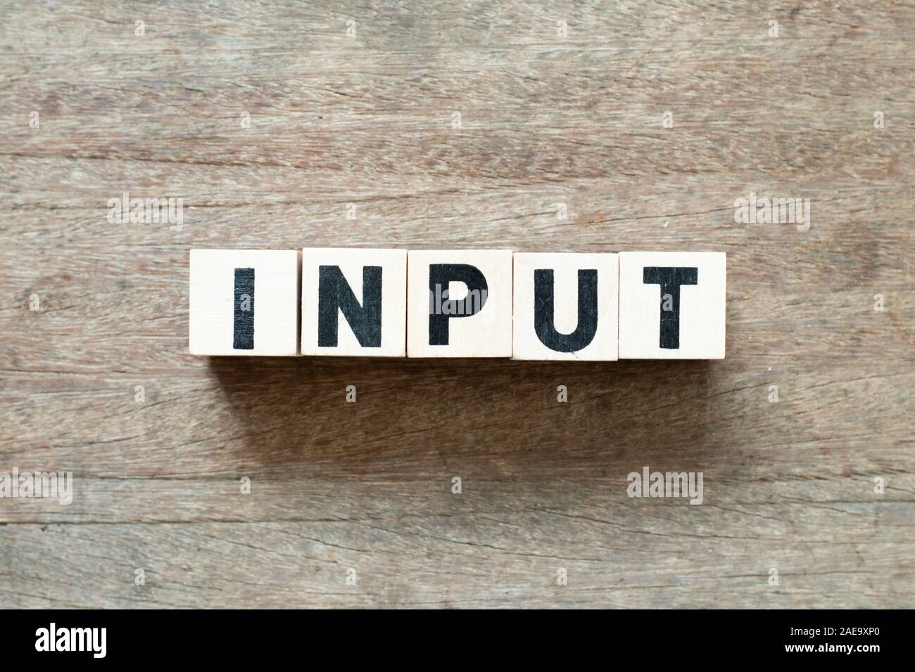 Letter block in word input on wood background Stock Photo - Alamy
