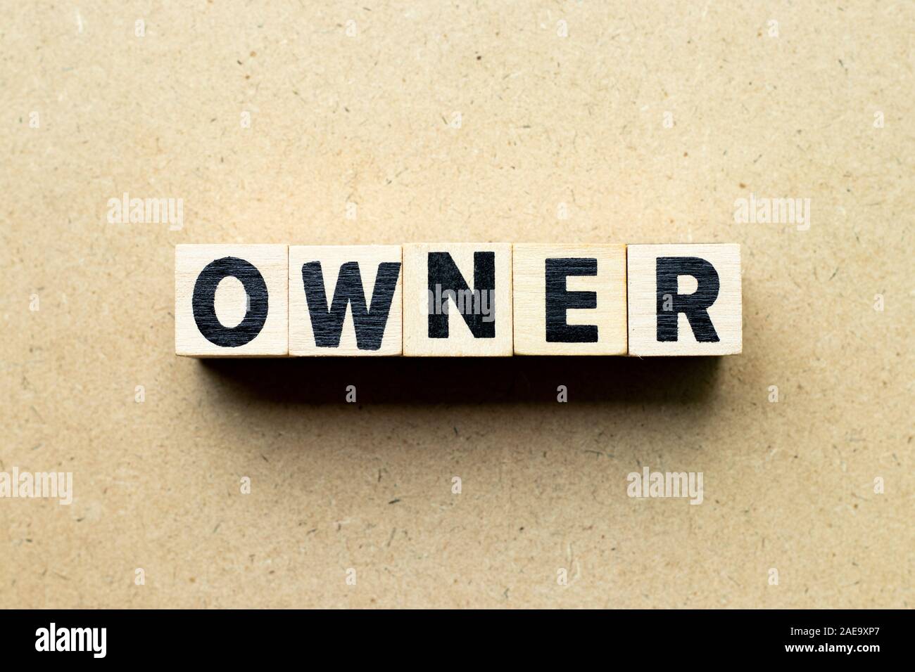 Letter block in word owner on wood background Stock Photo - Alamy