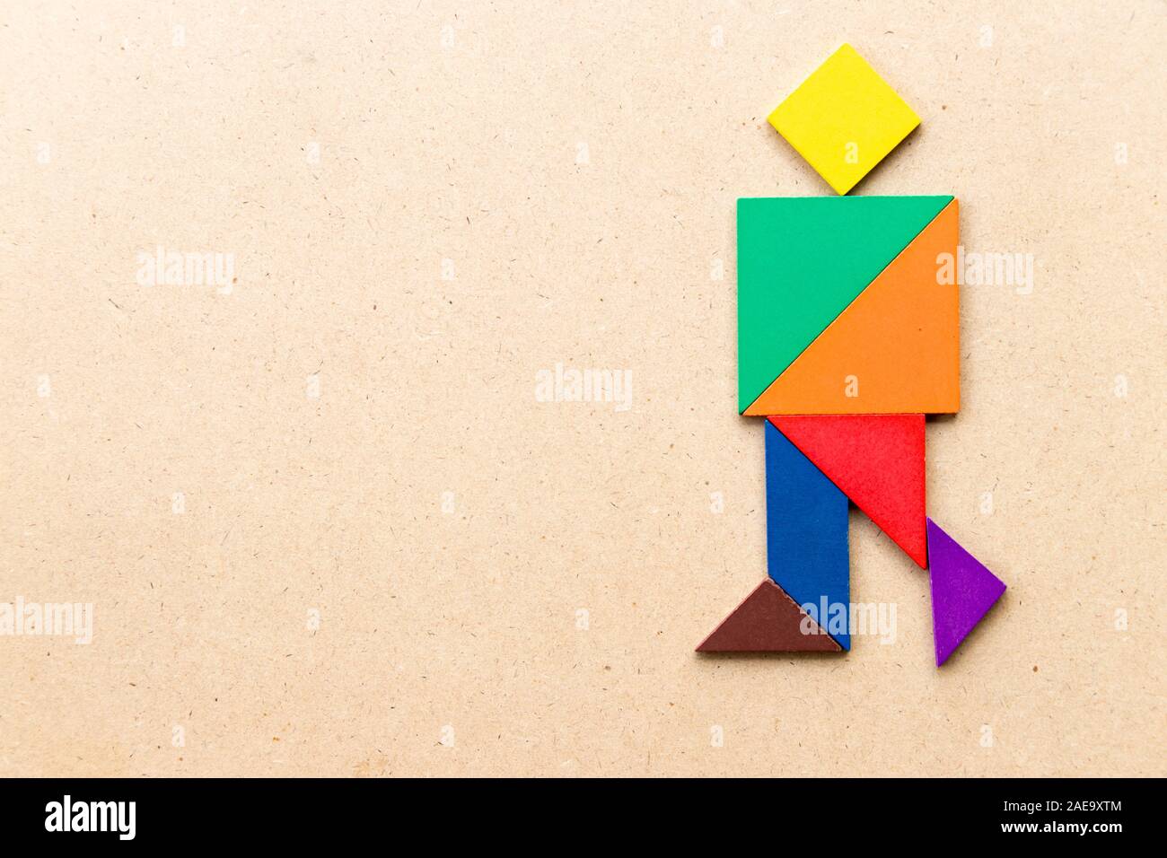 Color tangram puzzle in walking man shape on wood background Stock ...
