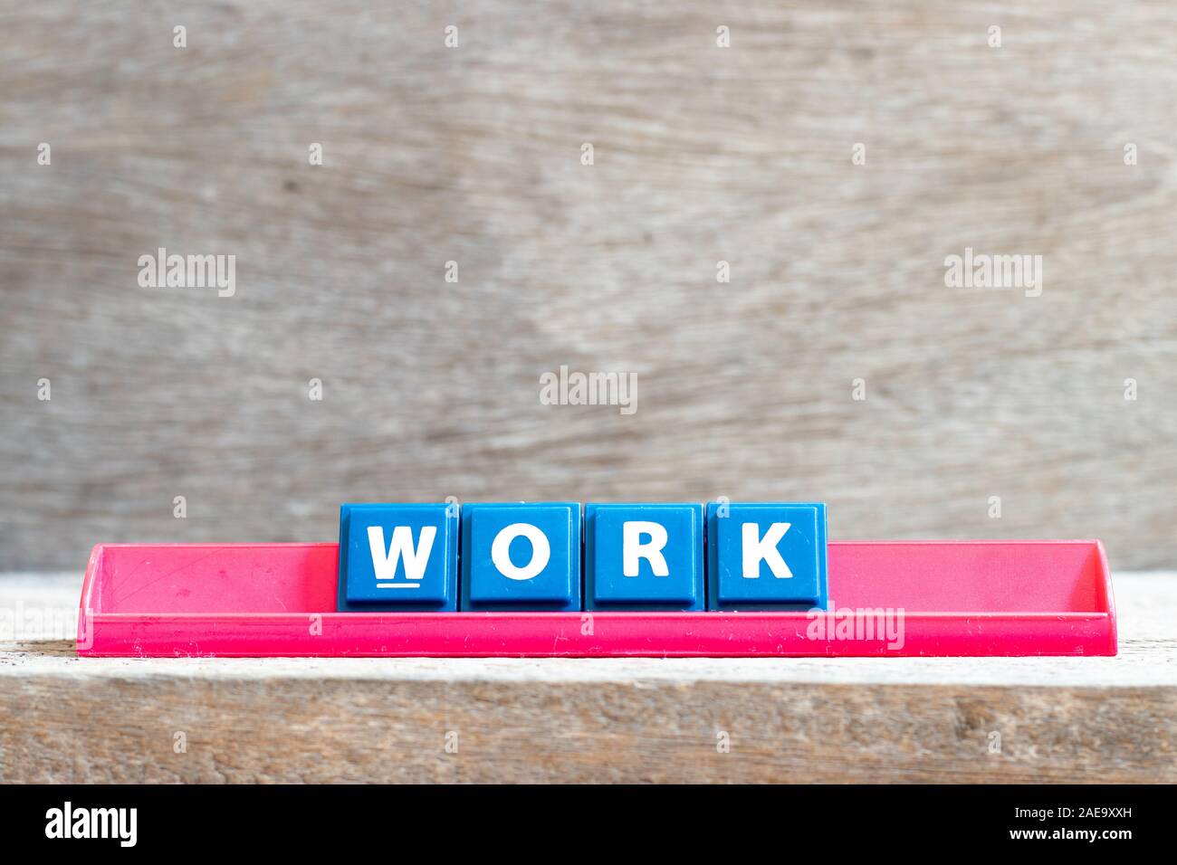 Tile letter on red rack in word work on wood background Stock Photo - Alamy