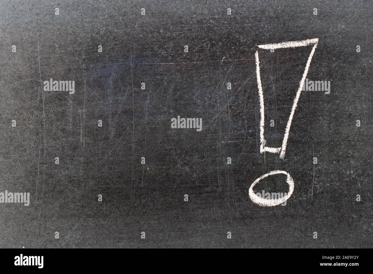 White color chalk hand drawing in exclamation mark with blank space ...