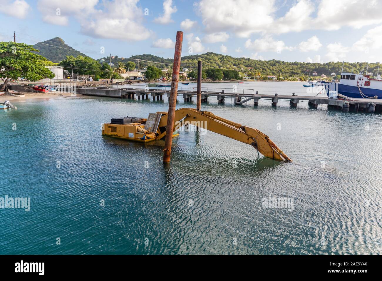 Dredging, pontoon excavator sunk in harbor in Carriacou, Grenada Stock ...