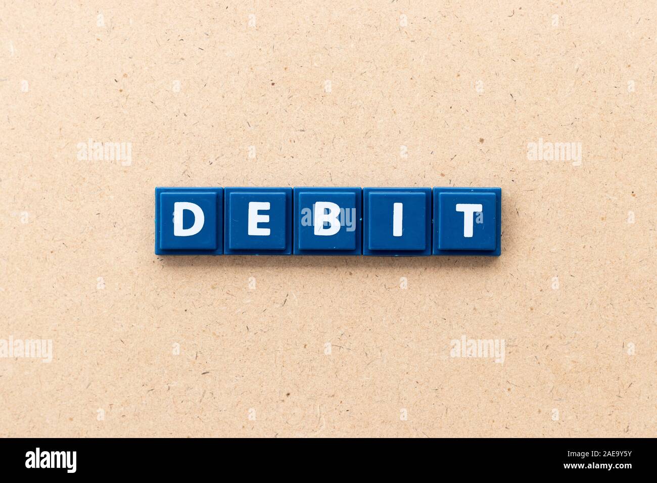 Tile letter in word debit on wood background Stock Photo - Alamy
